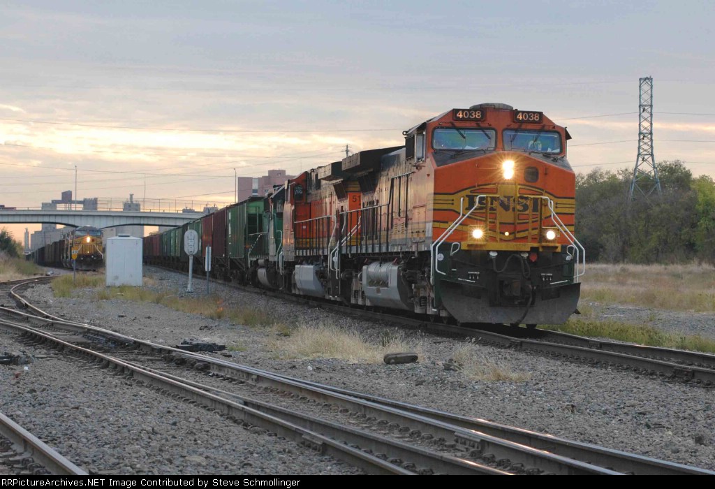 BNSF northbound manifest passes UP coal train at dusk at Tower 55